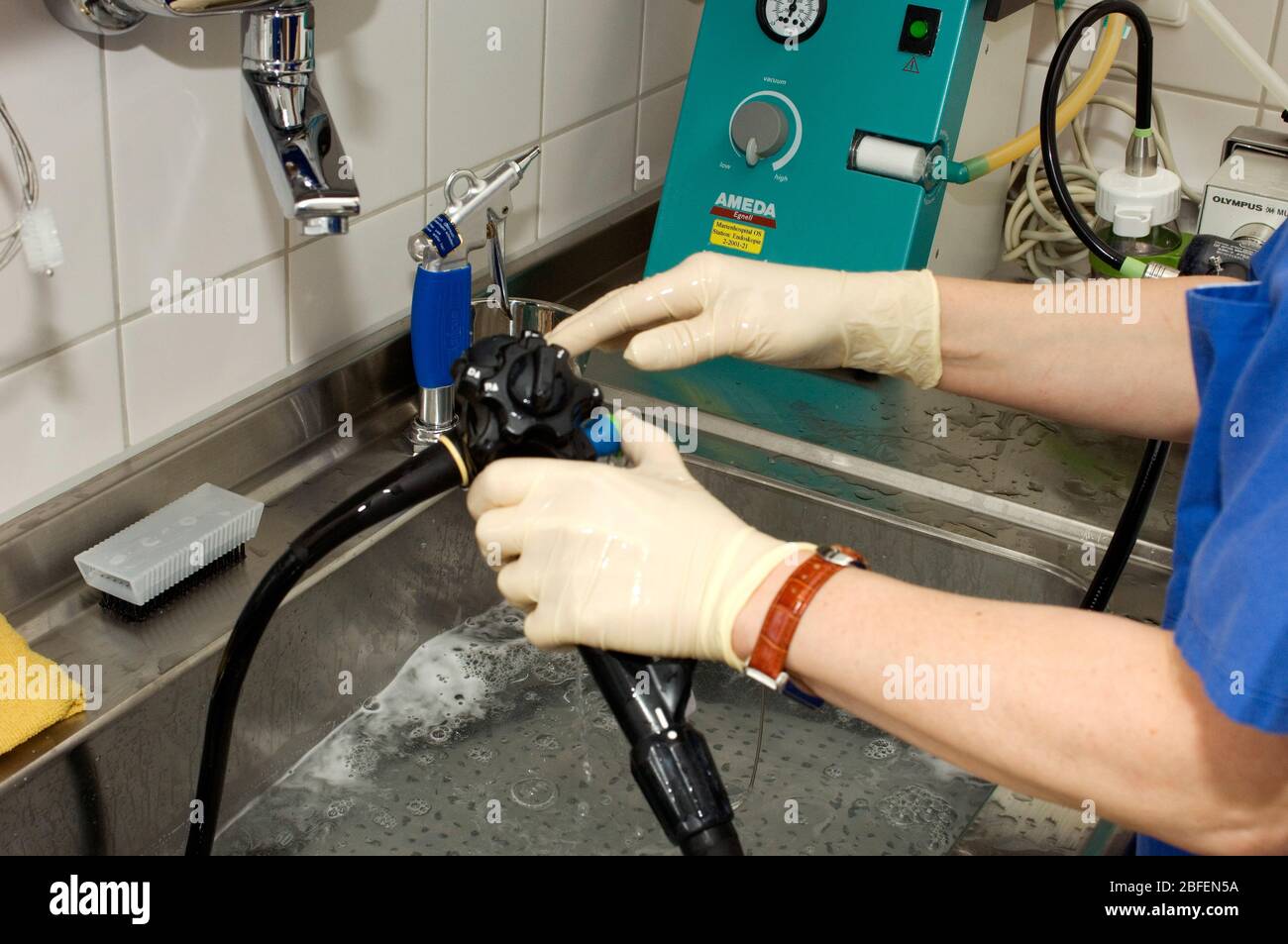 An endoscope being hand-washed before cleaning and sterillizing by ...
