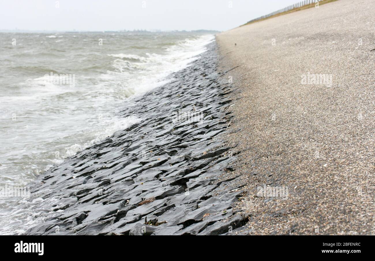 Detail view of a dam fortified with stones on the North Sea ...
