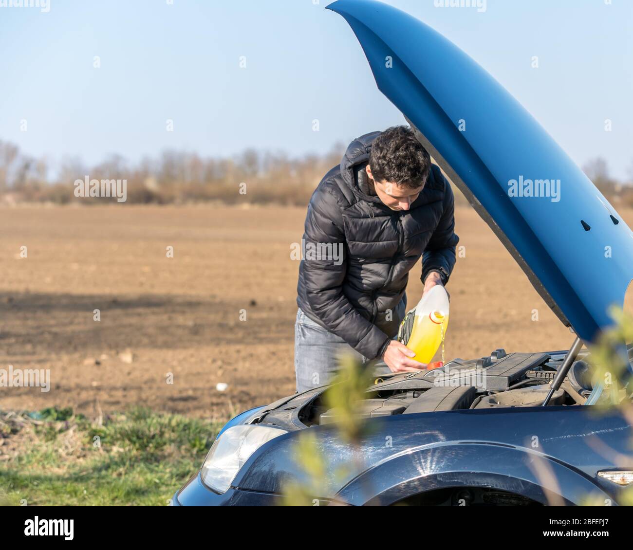 The man refills the windscreen washer fluid Stock Photo - Alamy