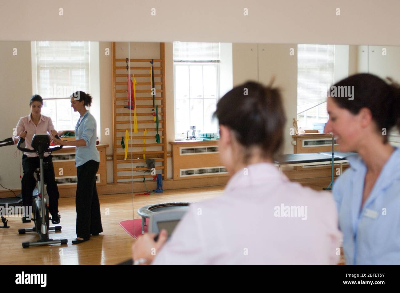 Mirrored reflection of a rehabilitation nurse instructing a patient how ...