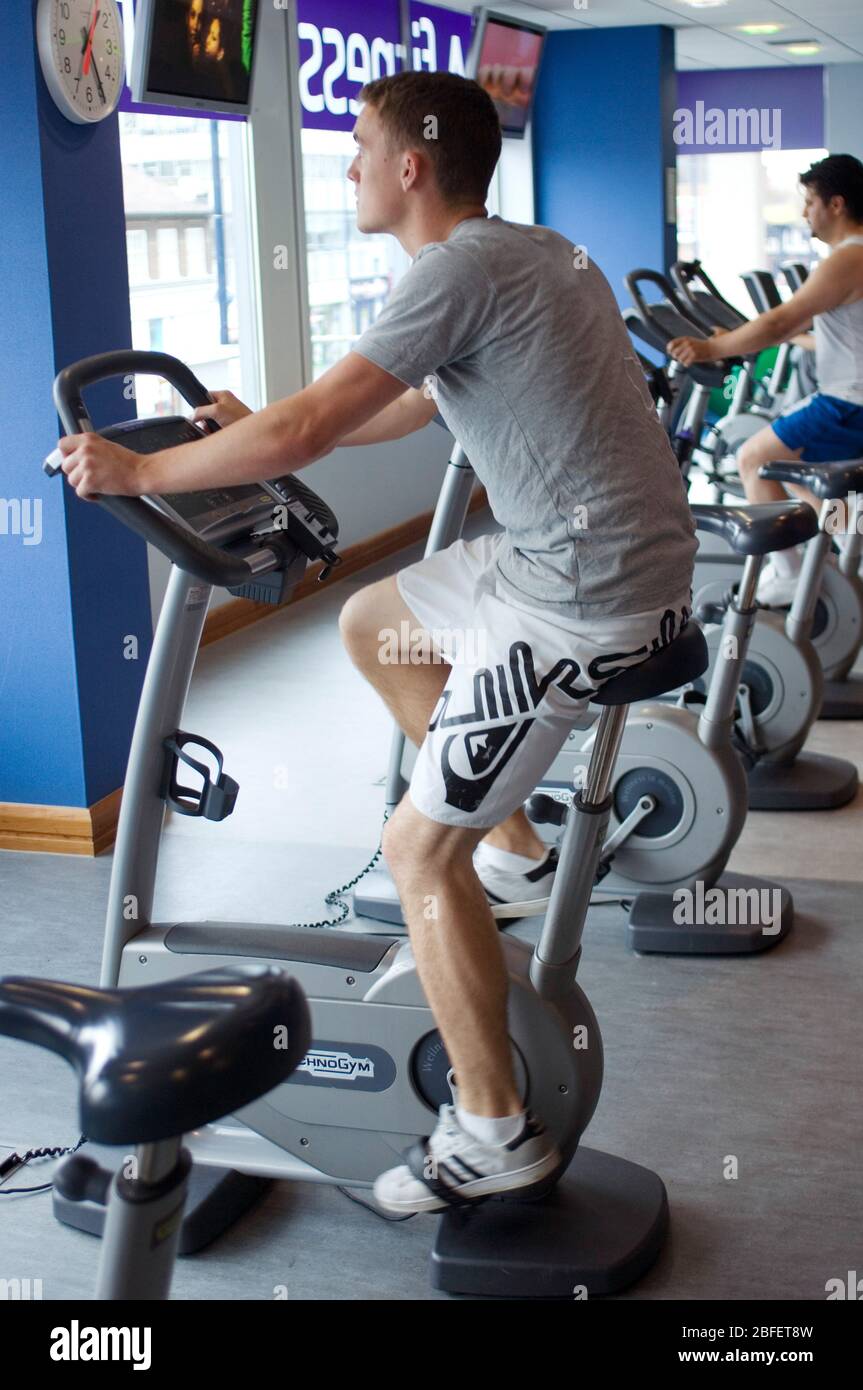 A man exercising on spinning cycles in a gym Stock Photo - Alamy