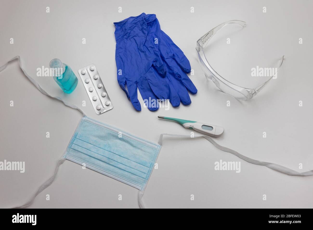 Medical gloves, face mask, protective eye wear, fever thermometer ...