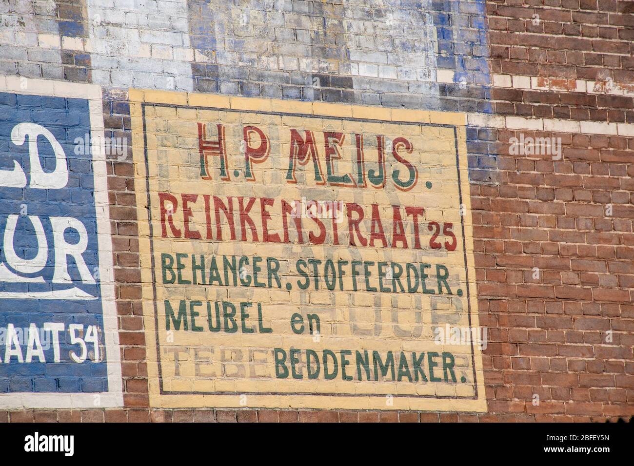 An old sign on the side of a brick building Stock Photo - Alamy