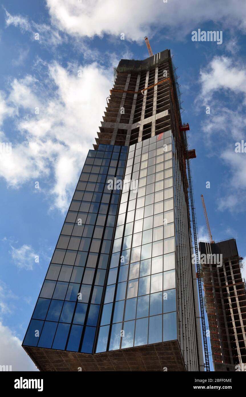 Construction of a modern multi-storey building made of glass and ...