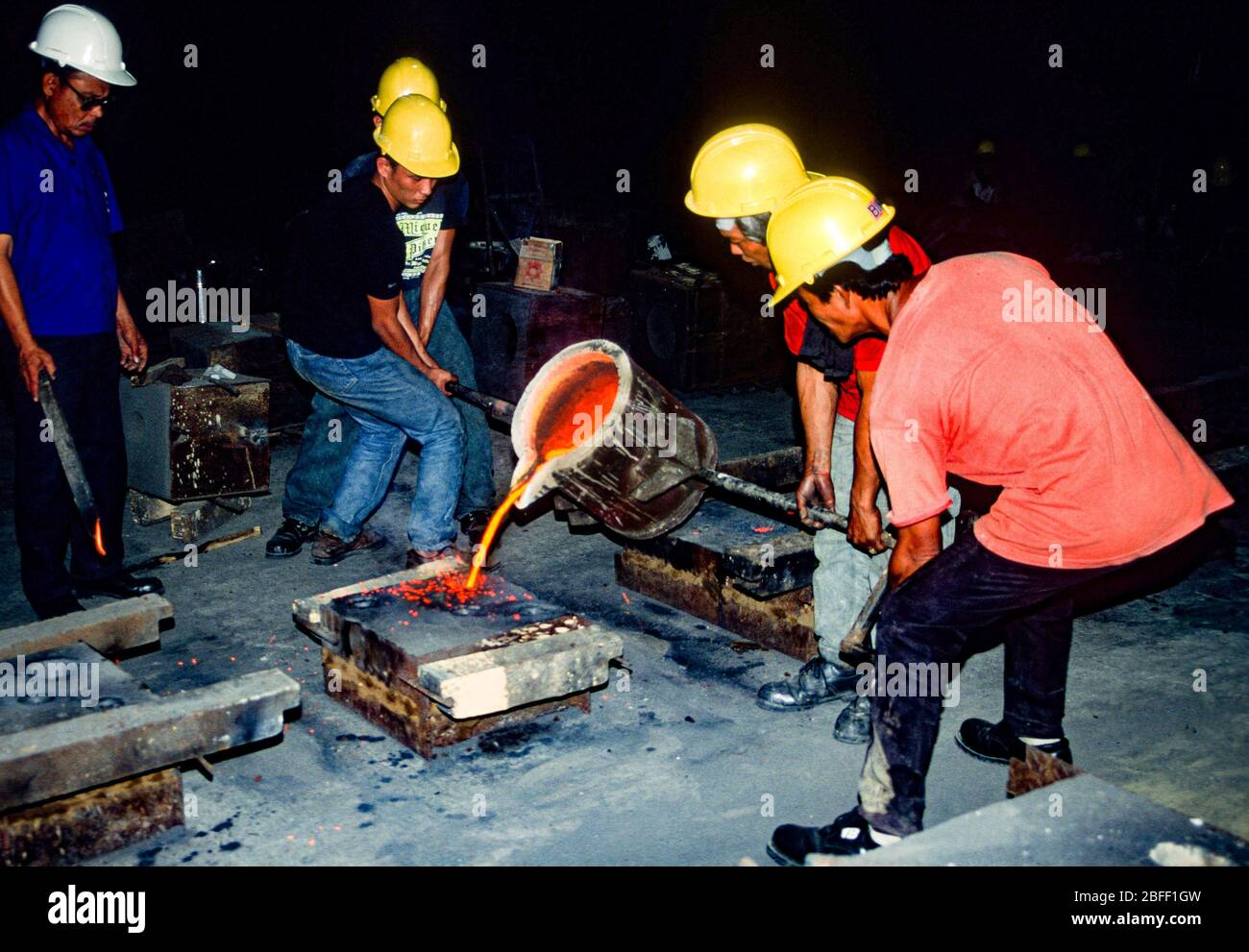 Metal workers pouring molten iron, Mindanao, Philippines, March 1996 ...