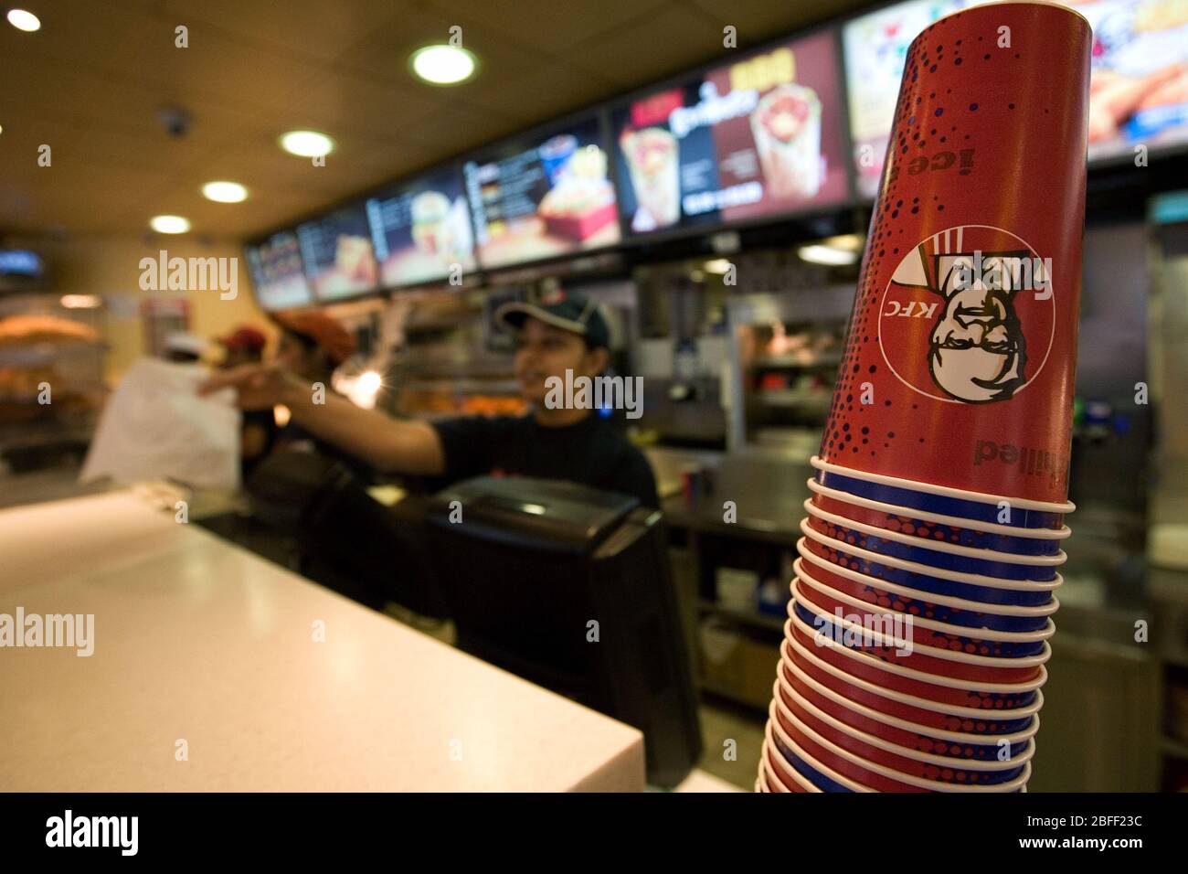 A KFC employee serving a hungry customer in the restaurant on Oxford ...