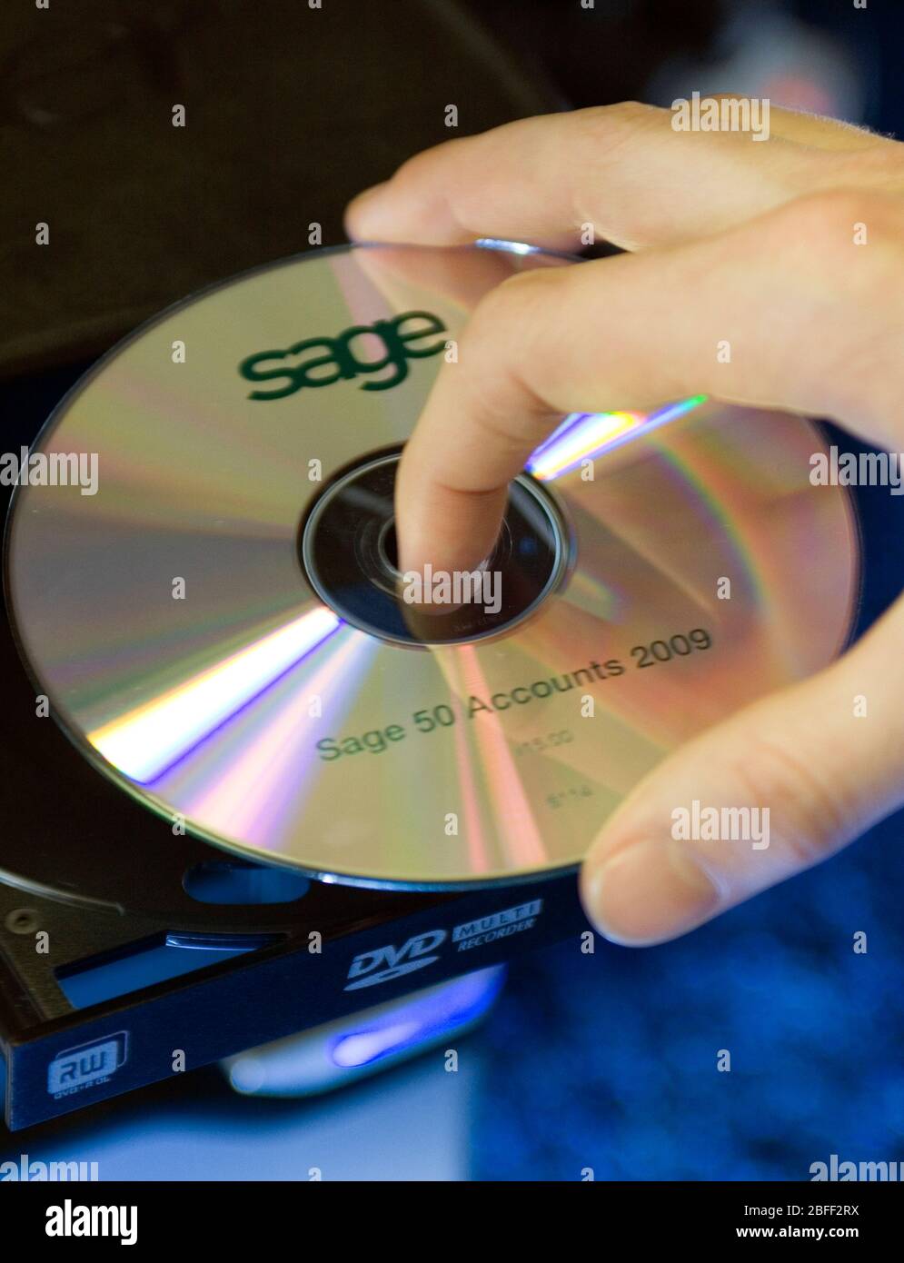 Sage '50 Accounts 2009' installation DVD being placed into PC DVD tray ...