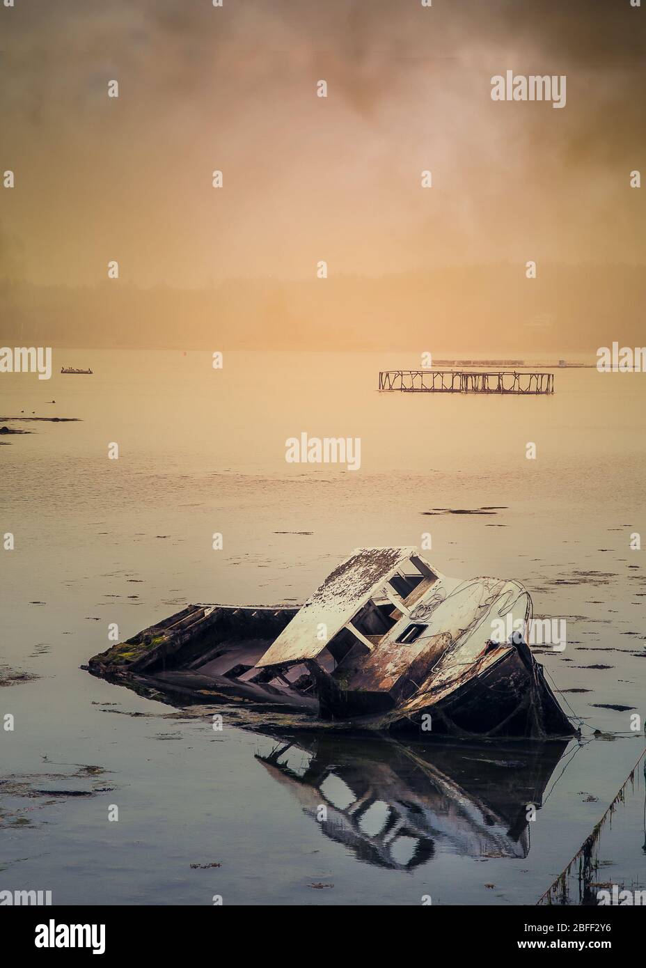 Old boat in water with dramatic storm sky Stock Photo - Alamy