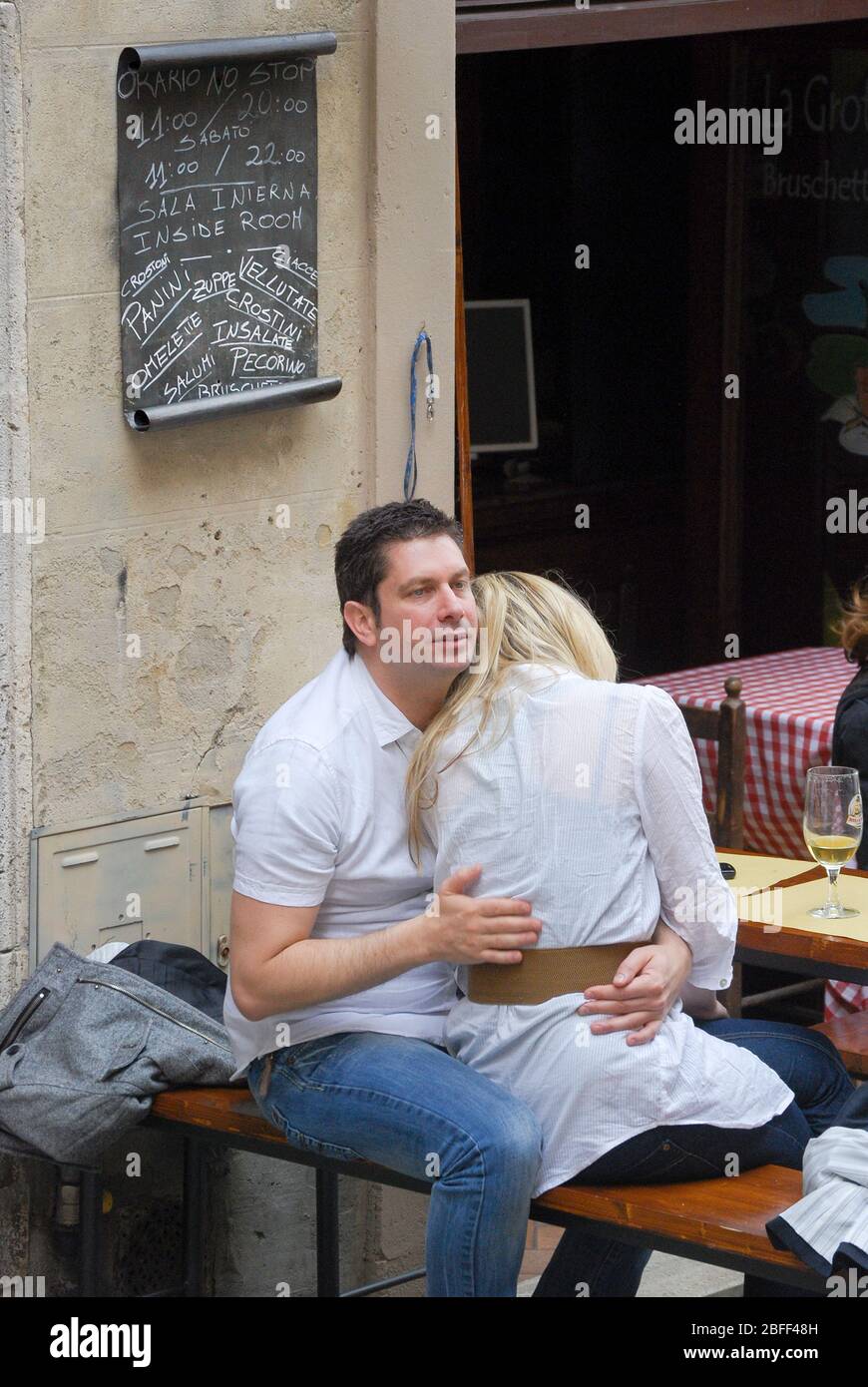 A man comforting his companion at a cafe in Montepulciano, Italy Stock ...