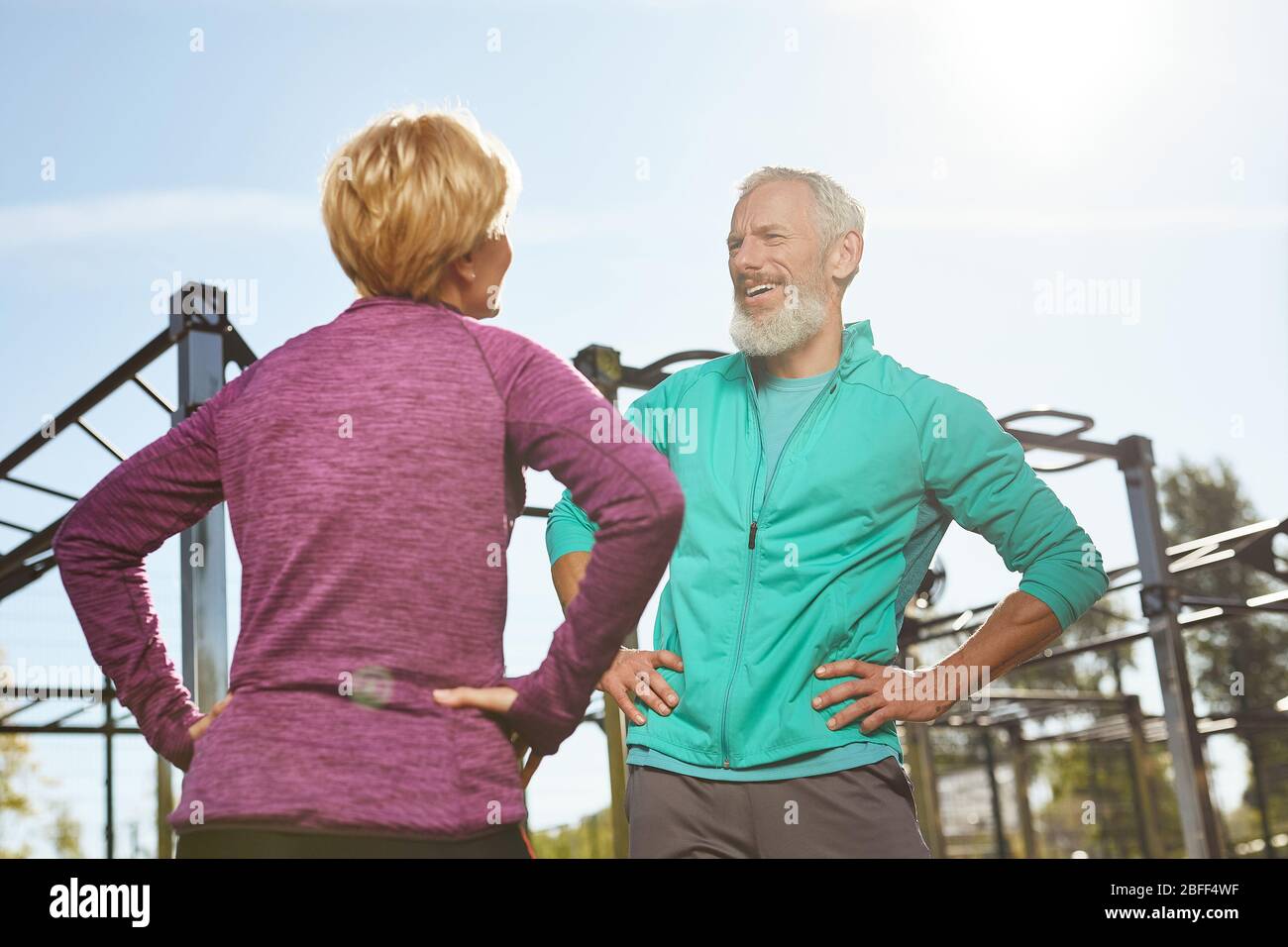 Morning exercises. Happy senior family couple in sportswear doing ...