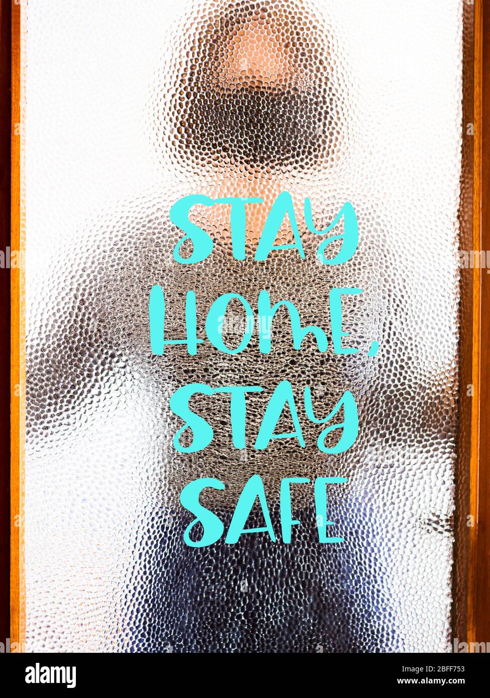 Woman in face mask behind door glass against covid Stock Photo - Alamy