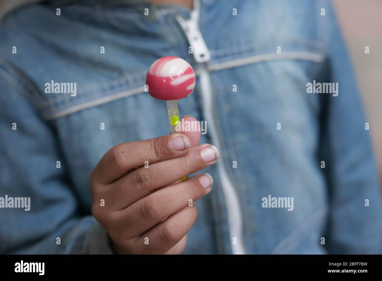 child buy hand holding candy, close up Stock Photo - Alamy