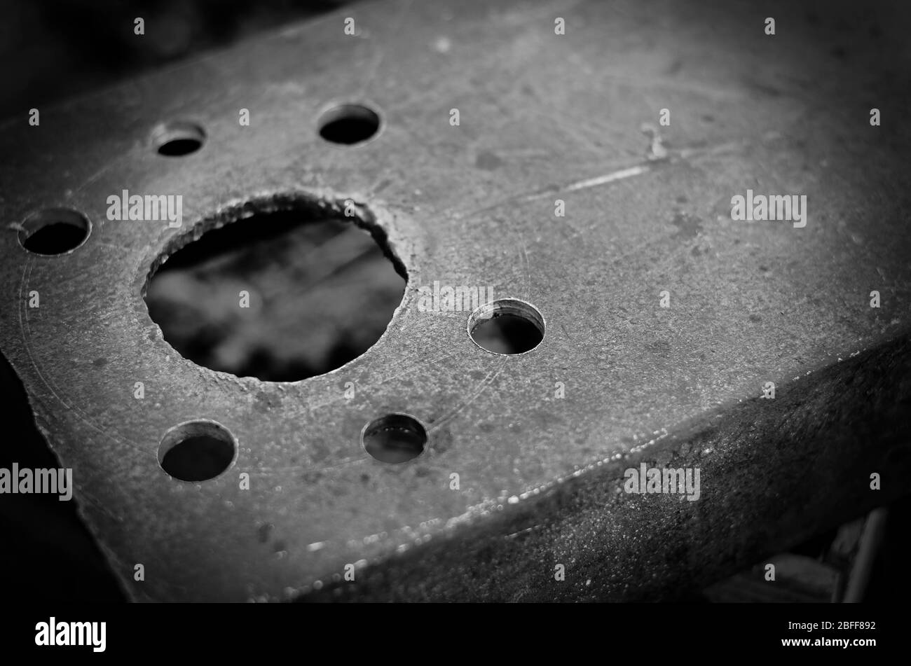 Drilled holes in the metal channel. Massive metal part with seven ...