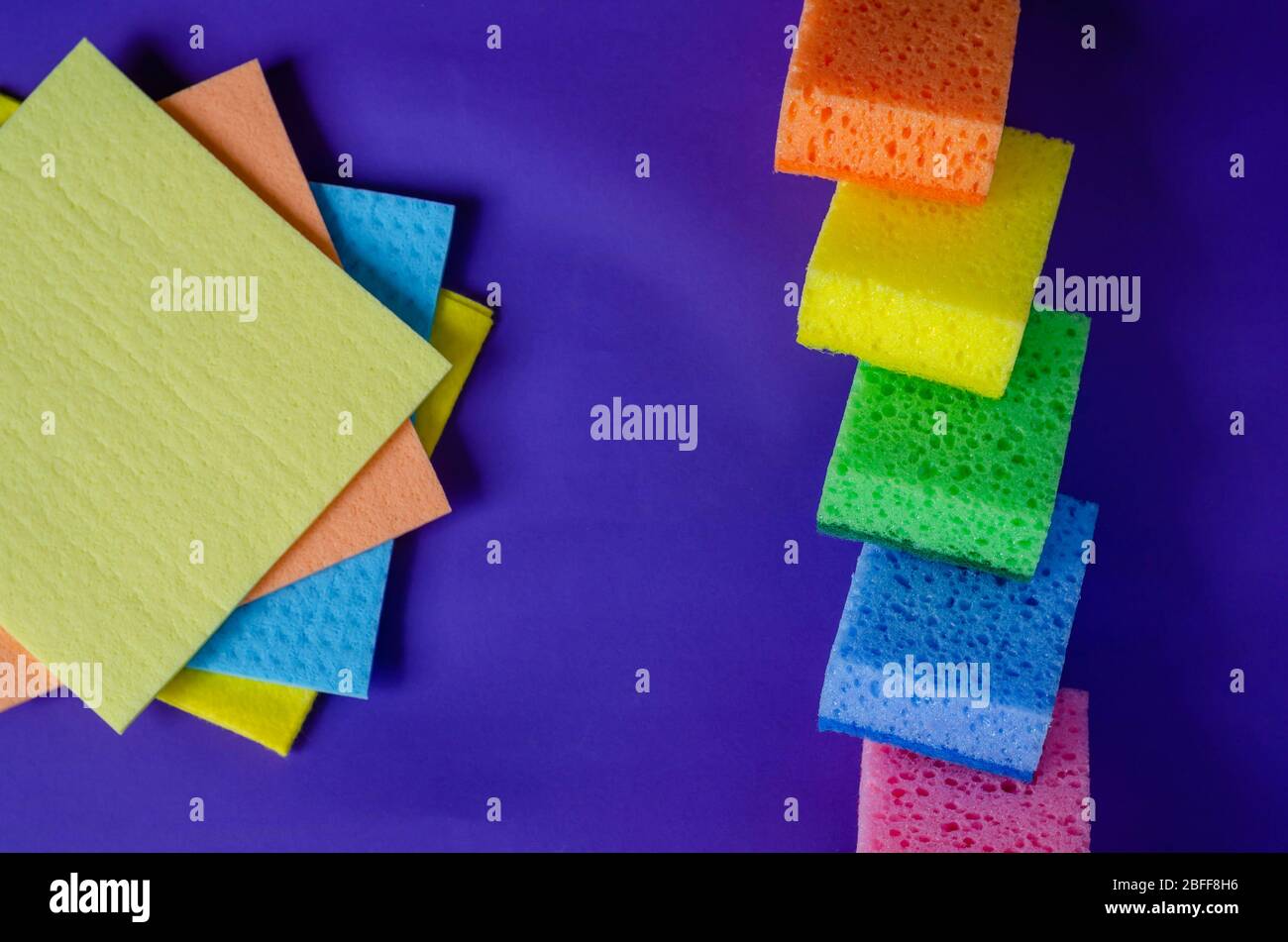 Kitchen napkins and sponges on a blue background. Set of multi-colored ...