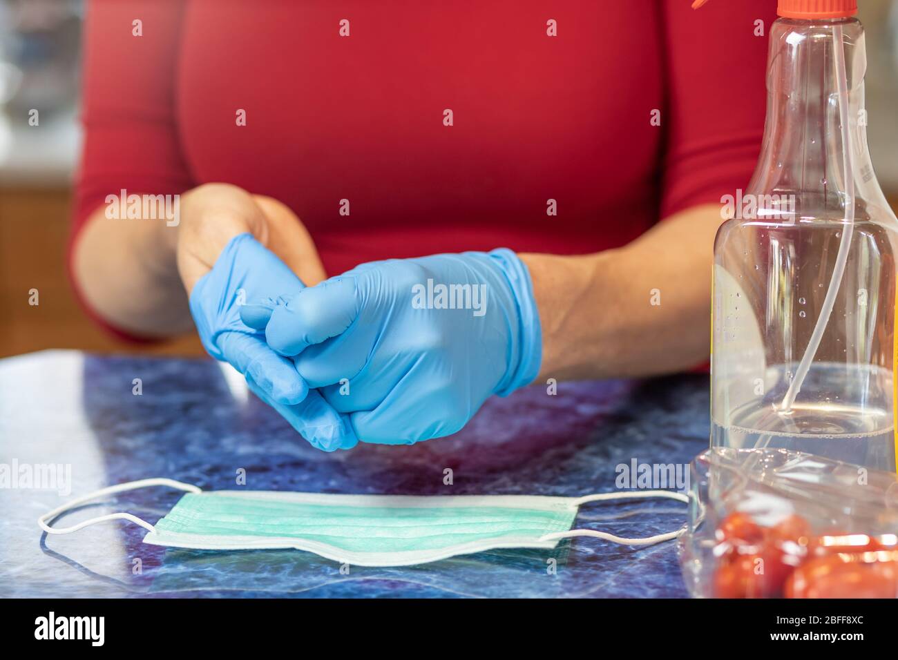 Woman taking off rubber gloves hi-res stock photography and images - Alamy