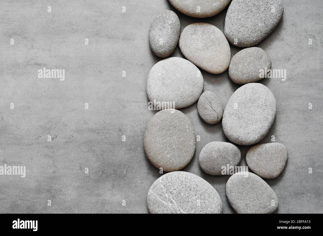 Gray spa stones and grey background. Spa concept Stock Photo - Alamy