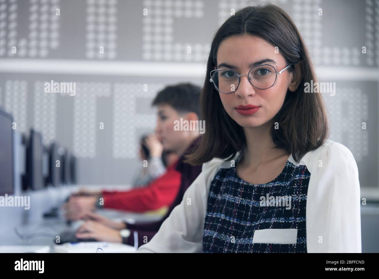 Side view of students using computer in lab. IT student looking and ...