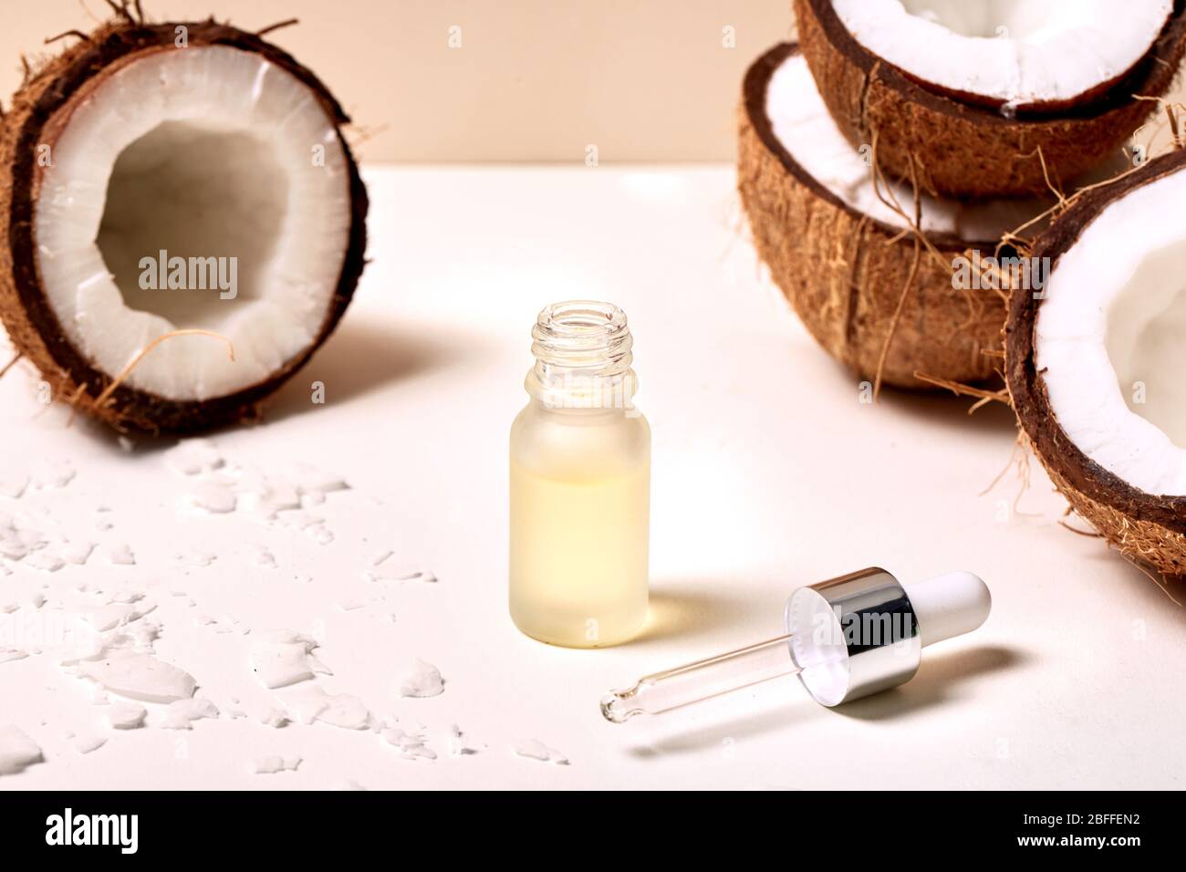 Bottle of serum oil with pipette and coconut shell Stock Photo - Alamy