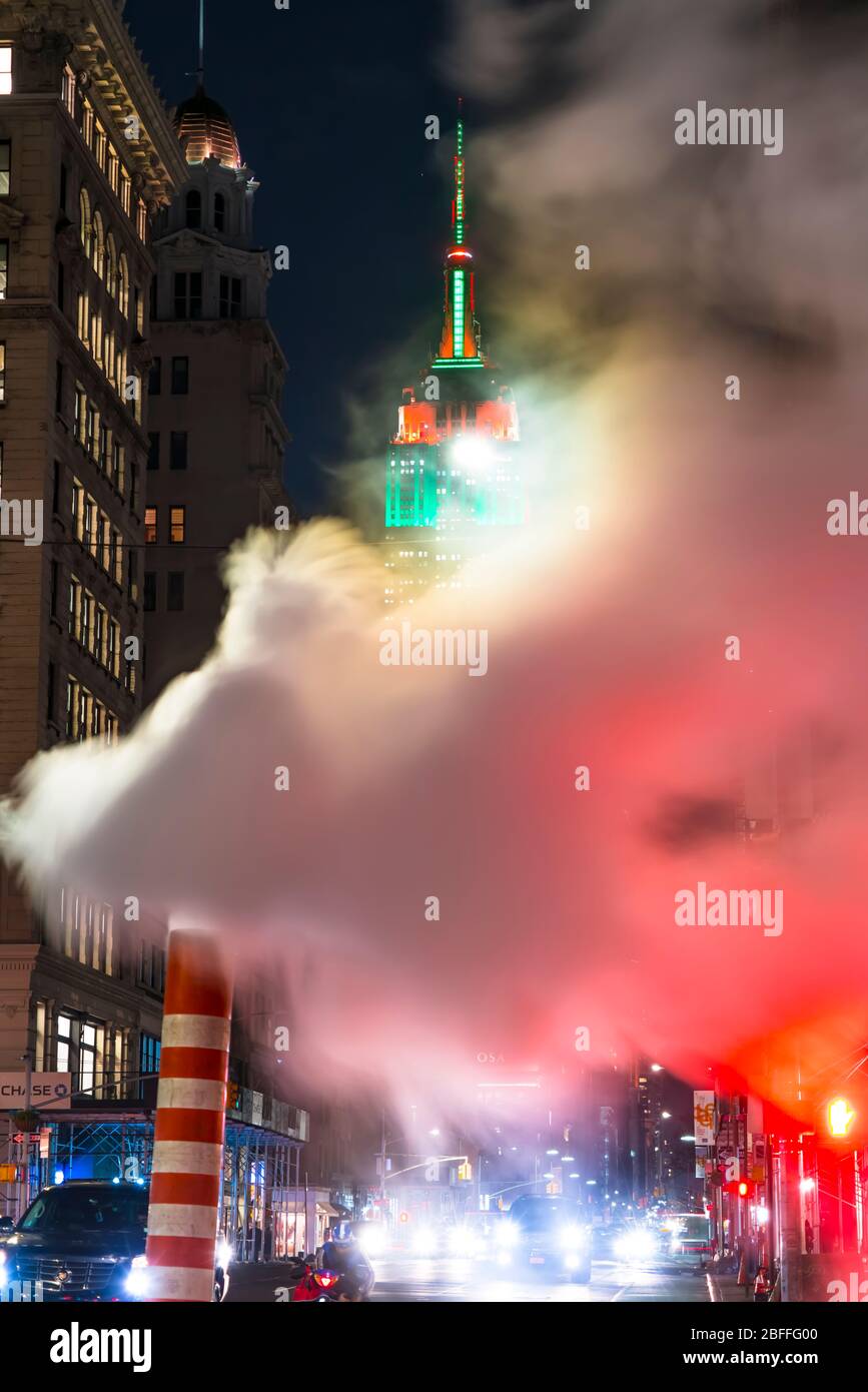 Empire State Building glows in Christmas Color behind the drifting ...