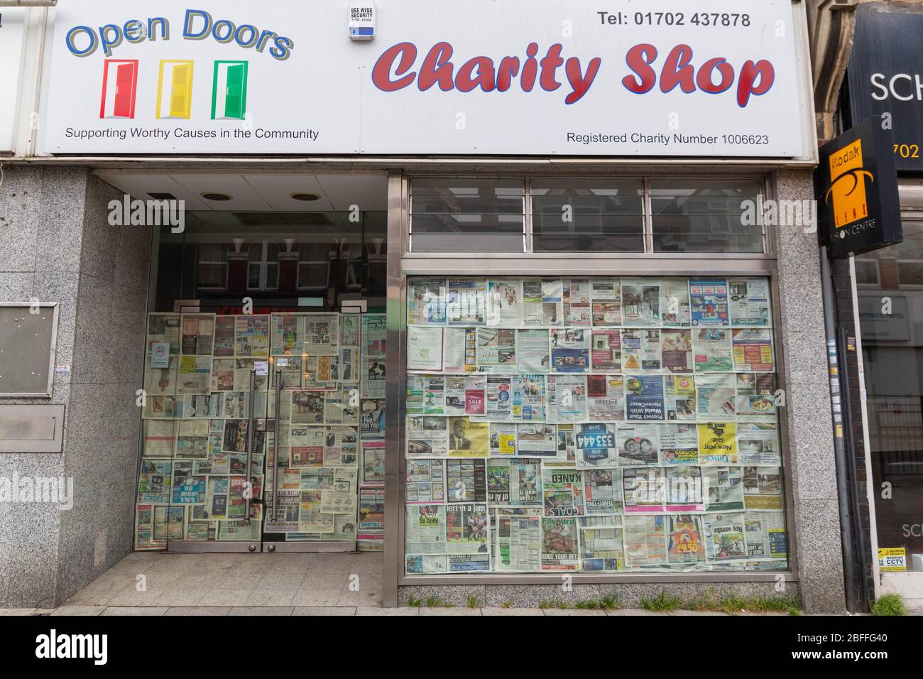 Closed charity shop, window, newspaper, open doors. Southend-on-Sea, UK ...