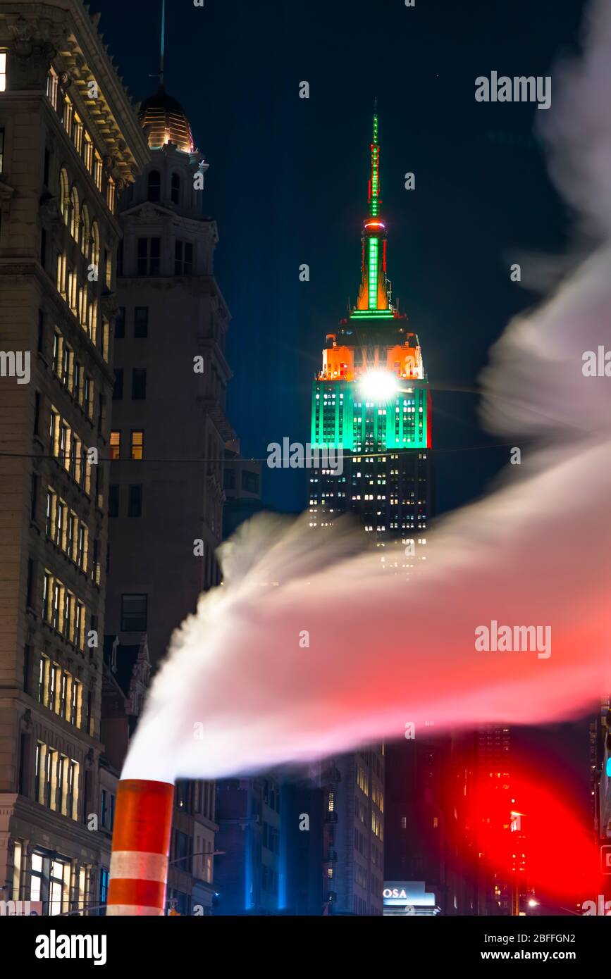 Empire State Building glows in Christmas Color behind the drifting ...