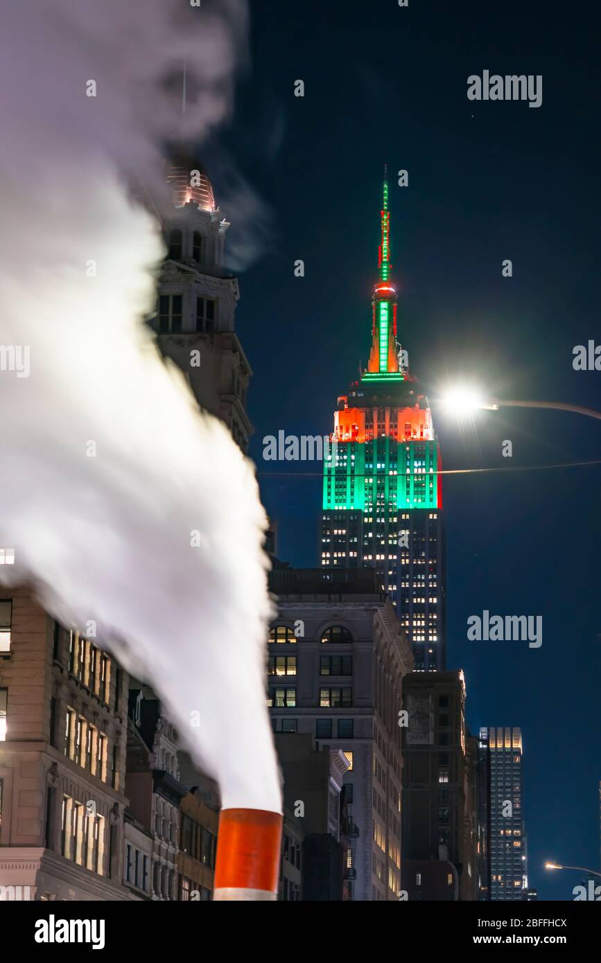 Empire State Building glows in Christmas Color behind the drifting ...
