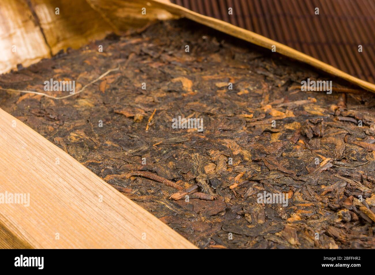 Chinese pressed PU-erh tea in bamboo leaf packaging, close-up, macro ...