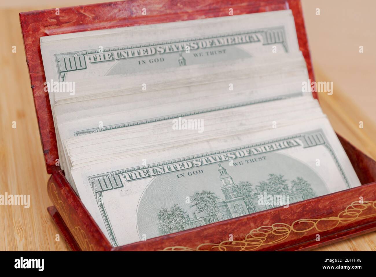 American hundred dollar bills in large quantities in a wooden box Stock ...