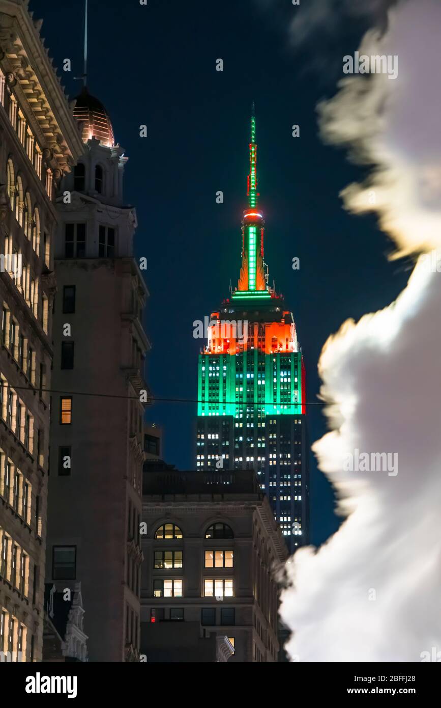 Empire State Building glows in Christmas Color behind the drifting ...