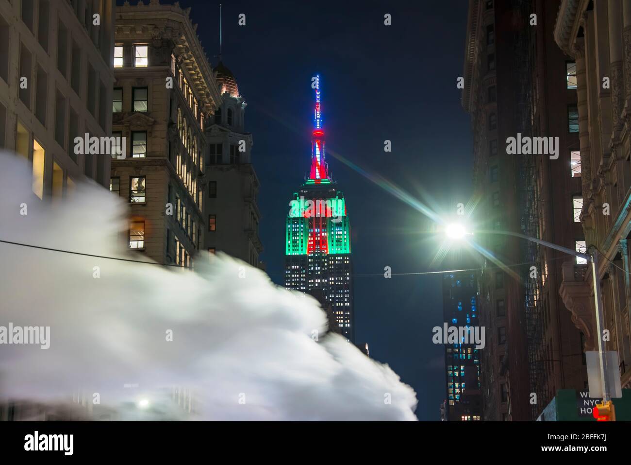 Empire State Building glows in Christmas Color behind the drifting ...