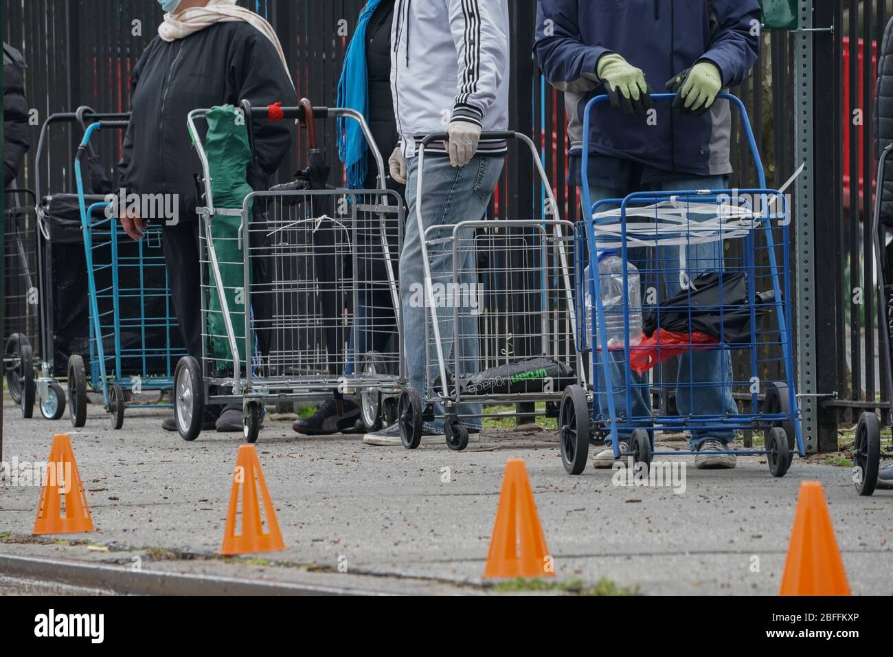 New York, NY, USA. 18th Apr, 2020. People pick up boxes with food ...