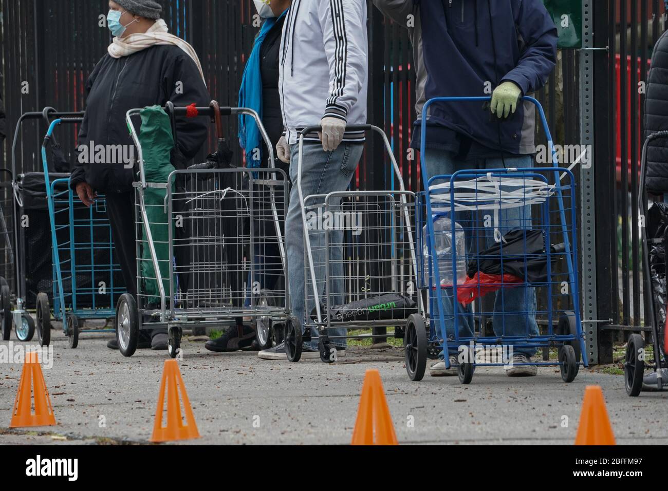 New York, NY, USA. 18th Apr, 2020. People pick up boxes with food ...