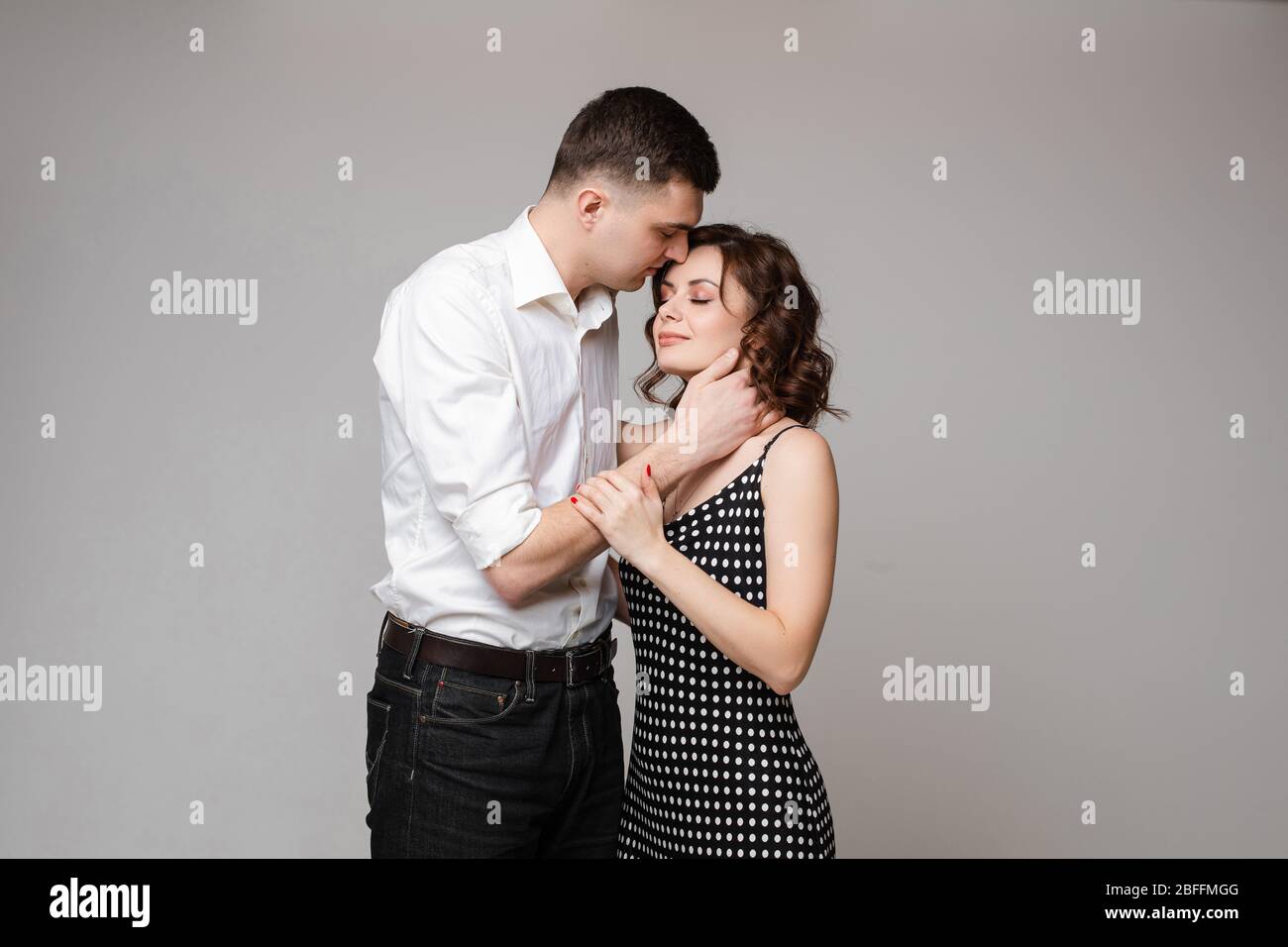 Loving couple snuggling on black background. Love concept Stock Photo ...
