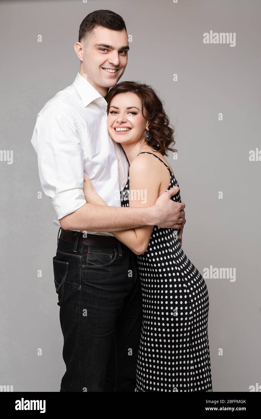 Loving couple snuggling on black background. Love concept Stock Photo ...