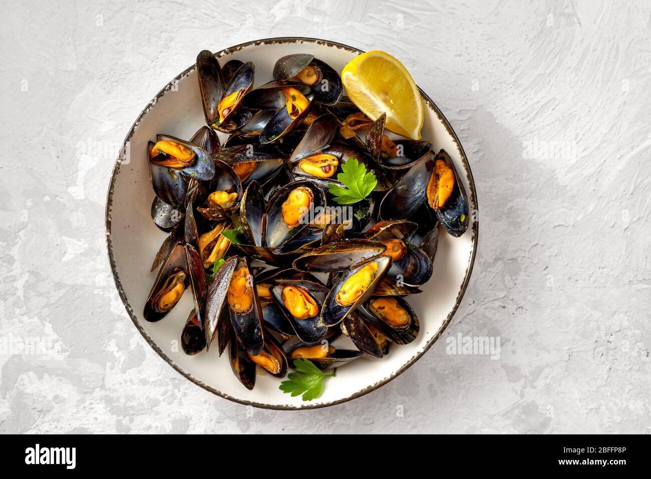 Healthy mussels in white plate on light gray background Stock Photo - Alamy
