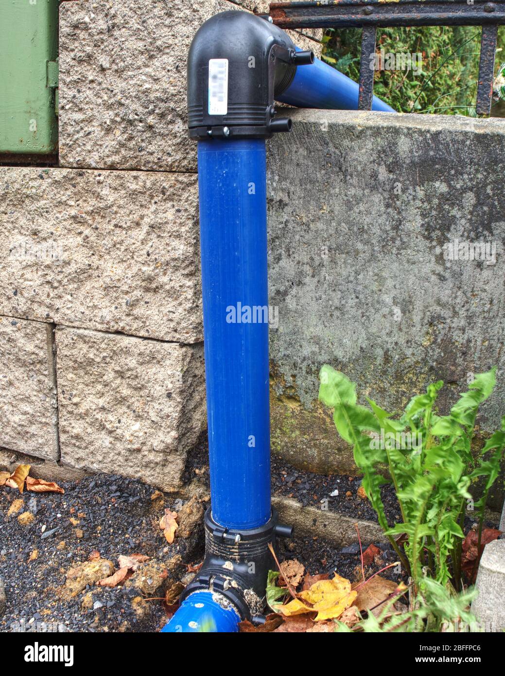 HDPE blue tube connected by black bent part to city drinking water ...
