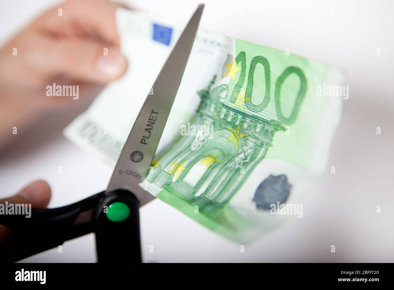 Illustrative image of a €100 note being cut Stock Photo - Alamy