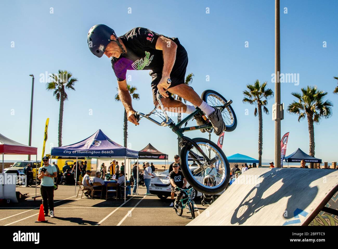 A BMX Freestyle Team biker jumps off a ramp in a skill demonstration in ...