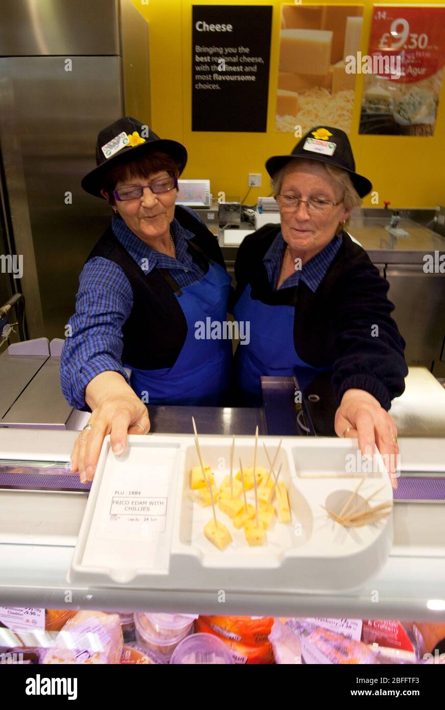 Staff handing out free samples at the cheese counter Stock Photo - Alamy