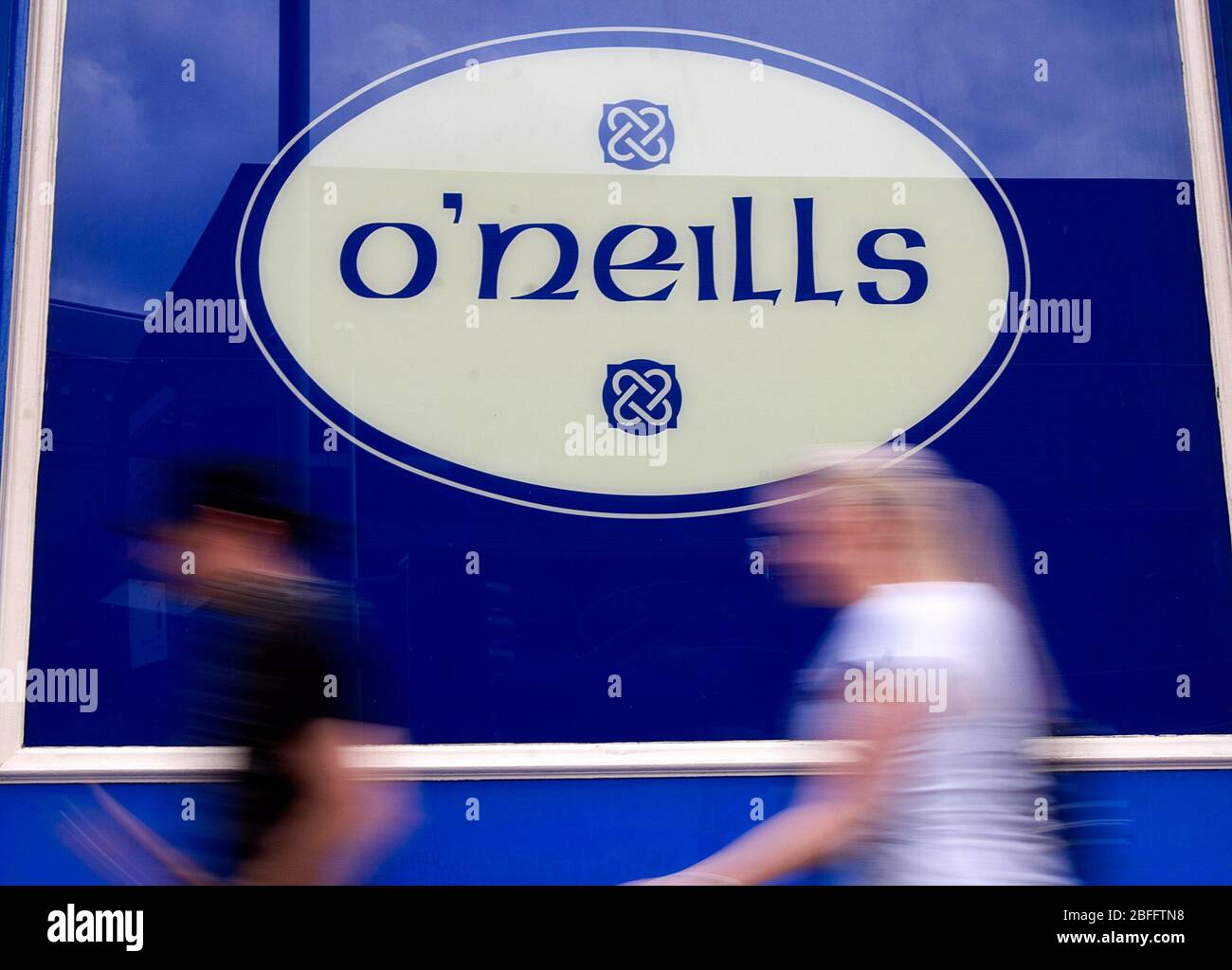 People pass by an O'Neills Pub which is a brand format of Mitchells and ...
