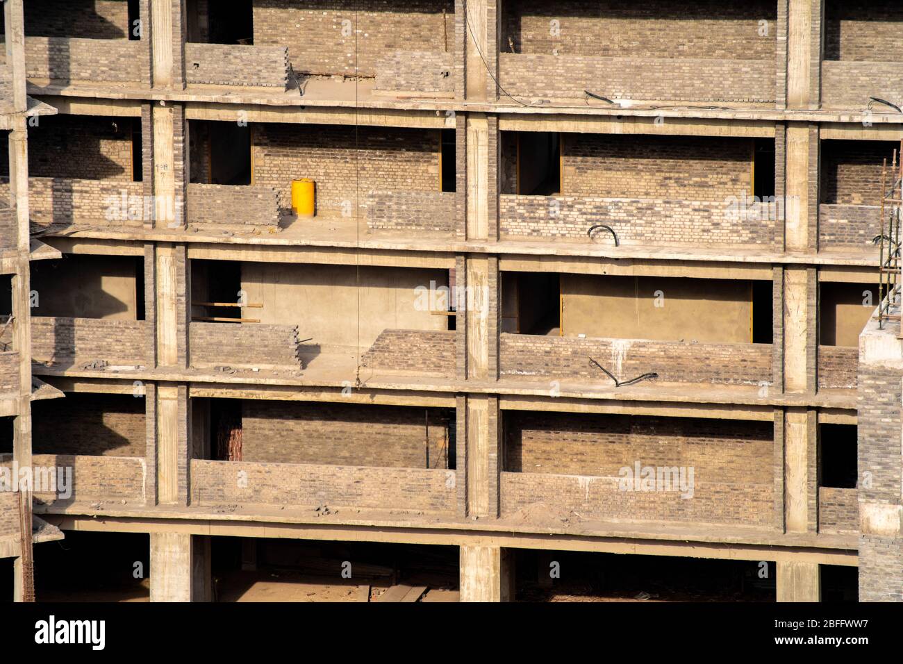 Close up aerial shot of an under construction multi story building with ...