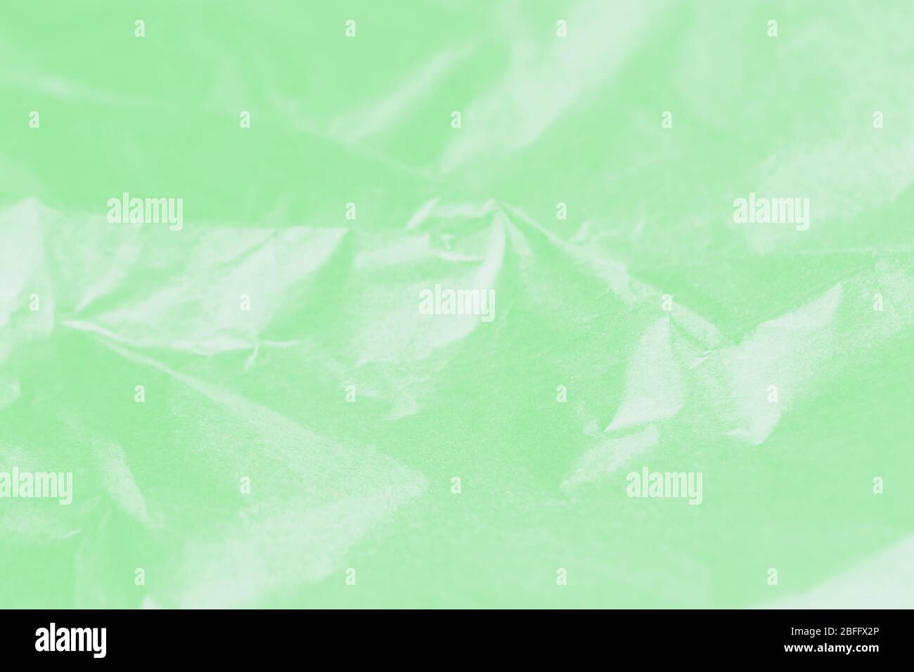 Crumpled green with light shadows paper texture abstract background ...