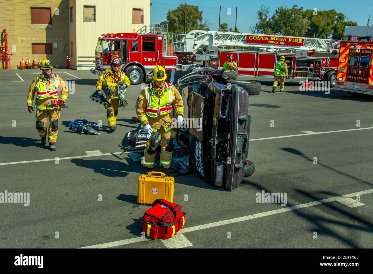 In a heavy rescue demonstration, fire fighters converge on an ...