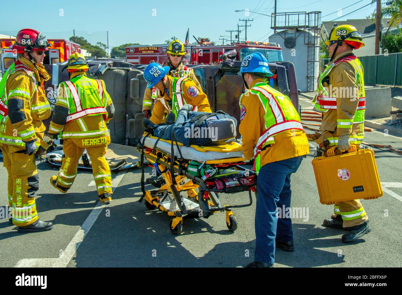 In a heavy rescue demonstration, fire fighters use a gurney remove a ...
