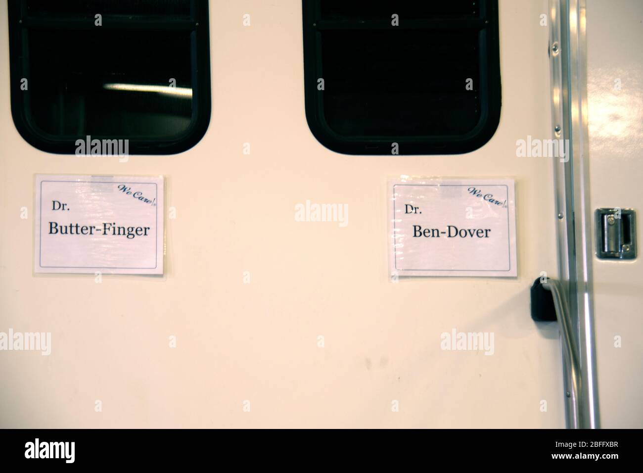 Humorous signs decorate the door of a private examining room for ...