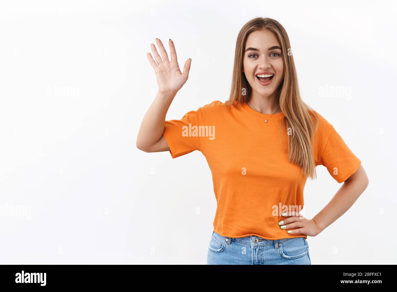 Hello neighbour. Smiling blond girl standing near window at home during ...