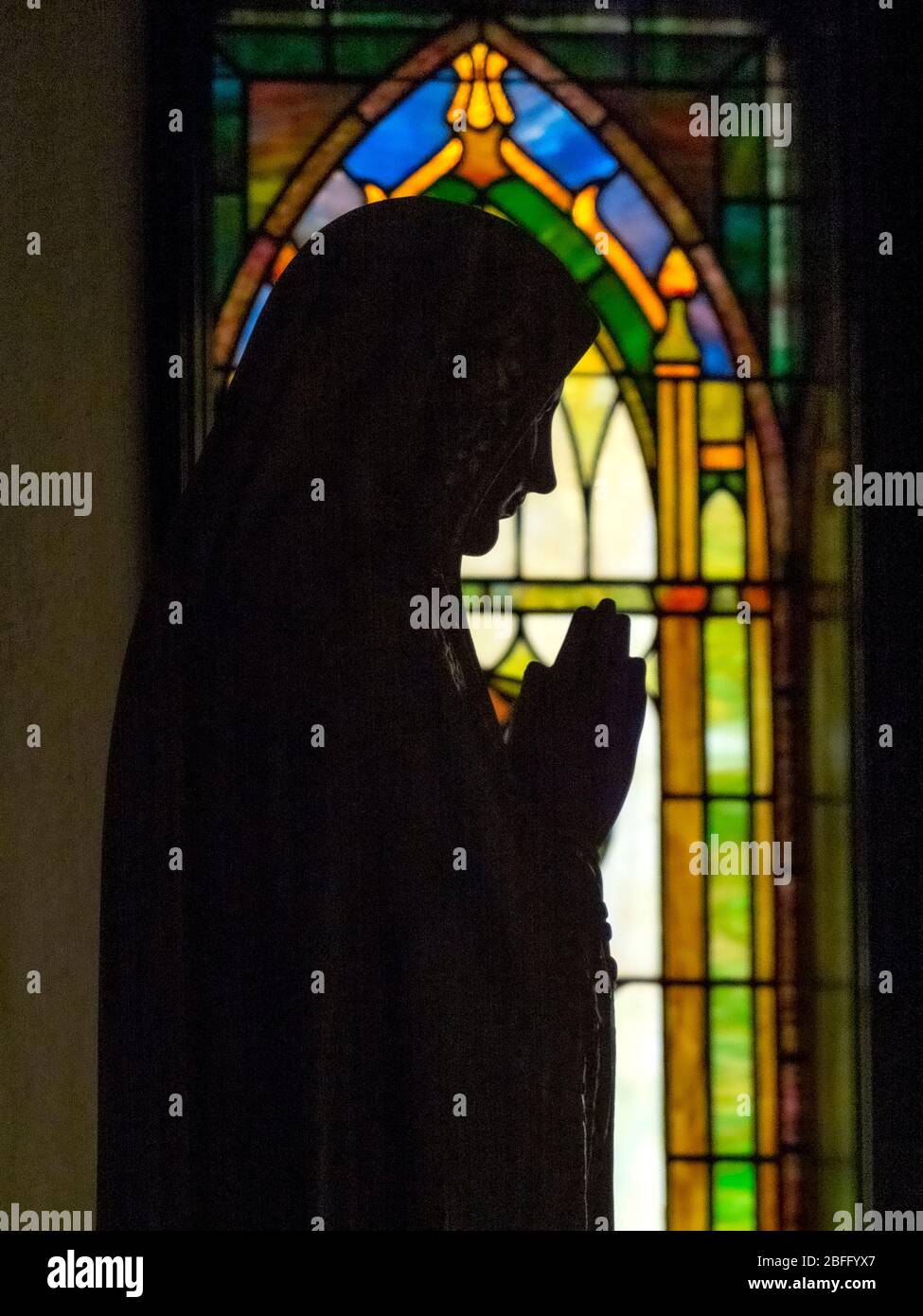 Praying stained glass window window hi-res stock photography and images ...