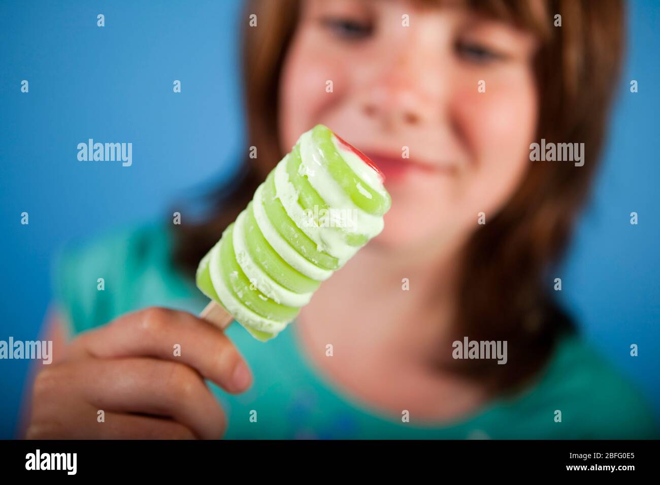 A young girl enjoys a Walls Twister ice-lolly, a Unilever brand Stock ...