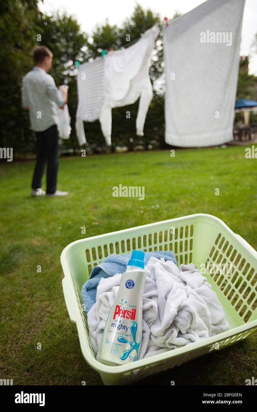 A young man hangs up his washing Stock Photo - Alamy