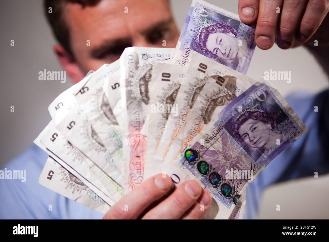 A fistful of various denomination sterling notes Stock Photo - Alamy